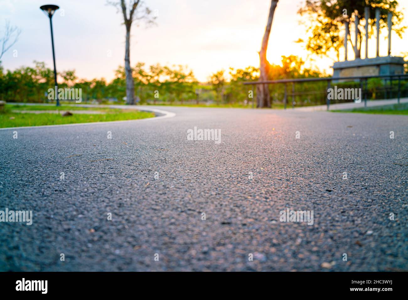 Empty asphalt pathway road in city park sunset running path Stock Photo ...