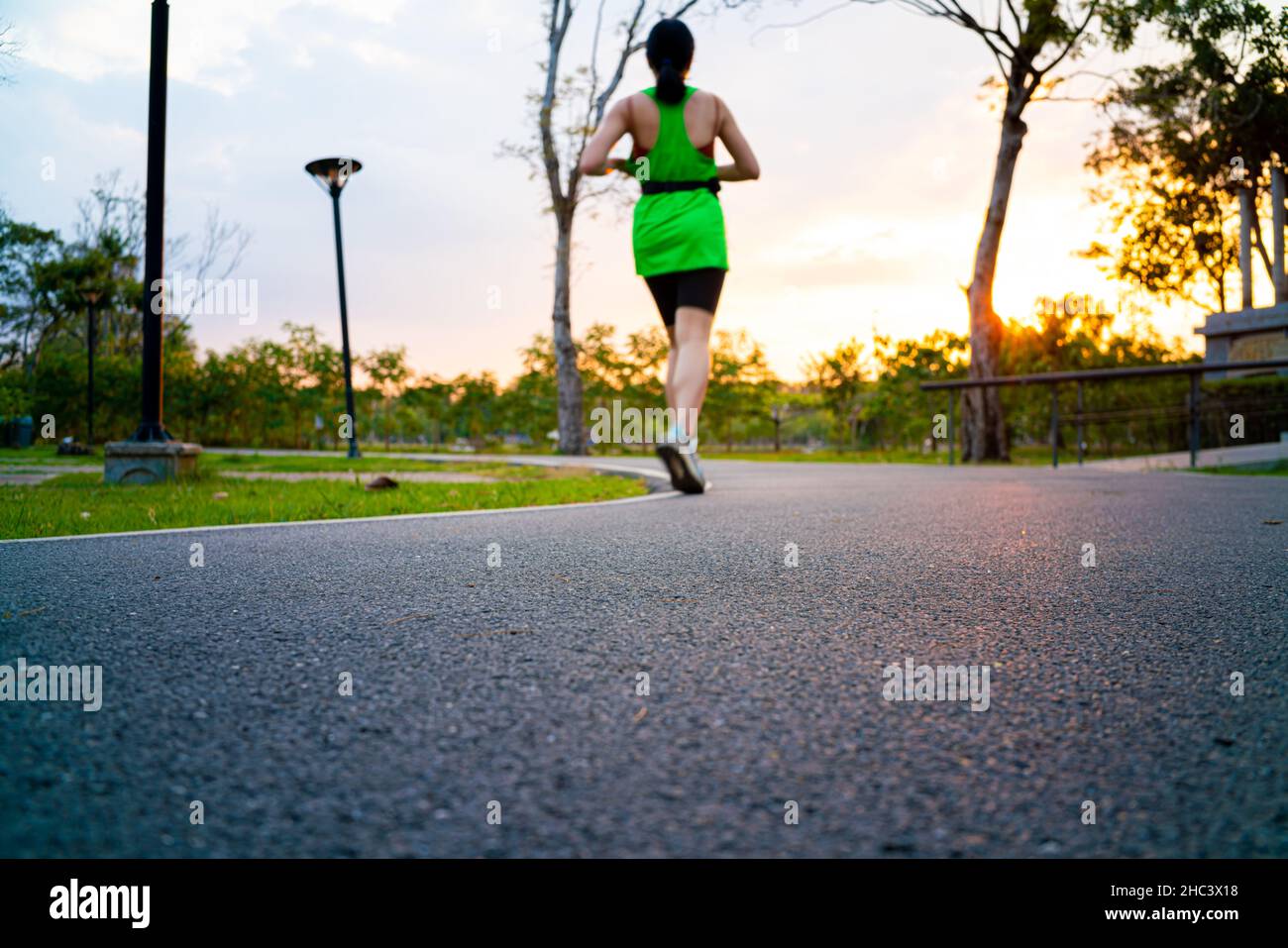 Empty asphalt pathway road in city park sunset running path Stock Photo ...