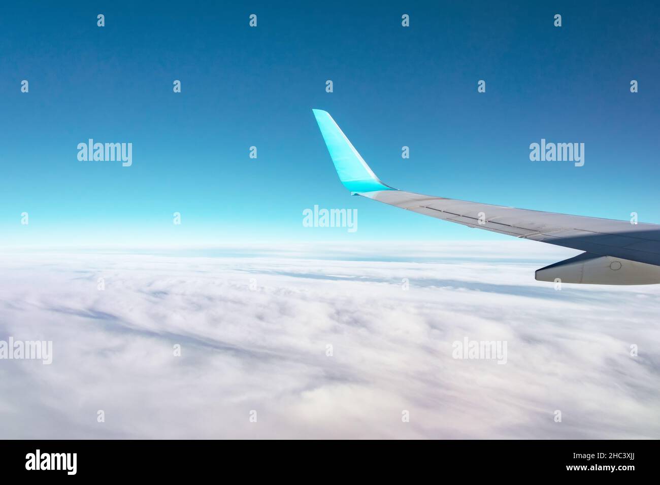 Wings of large passenger aircraft, flying at high altitude Stock Photo ...