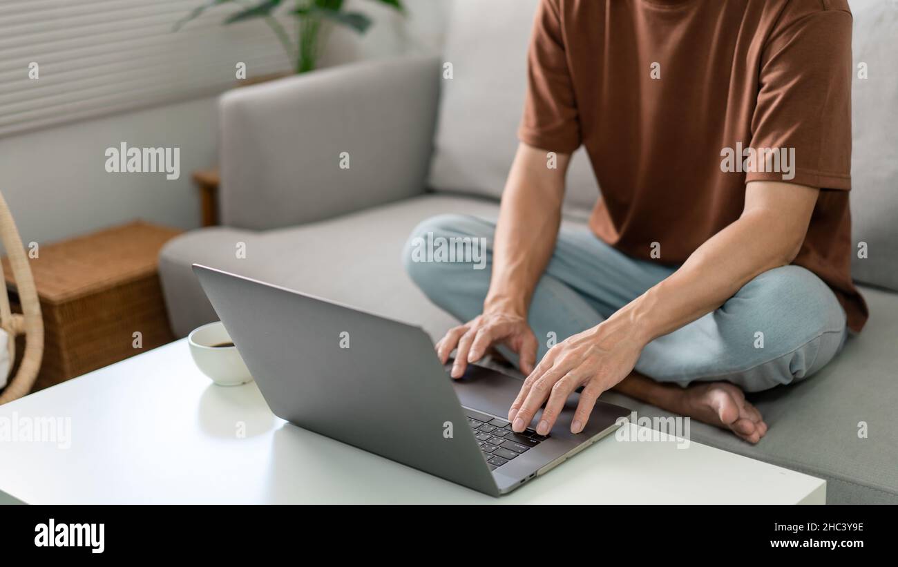 Technology Concept The man in brown T-shirt concentrating on typing ...