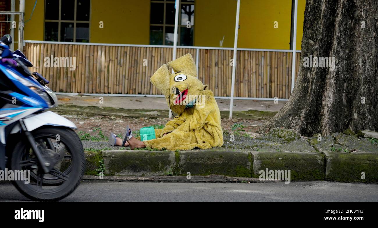 An exhausted clown on the side of the road Stock Photo - Alamy