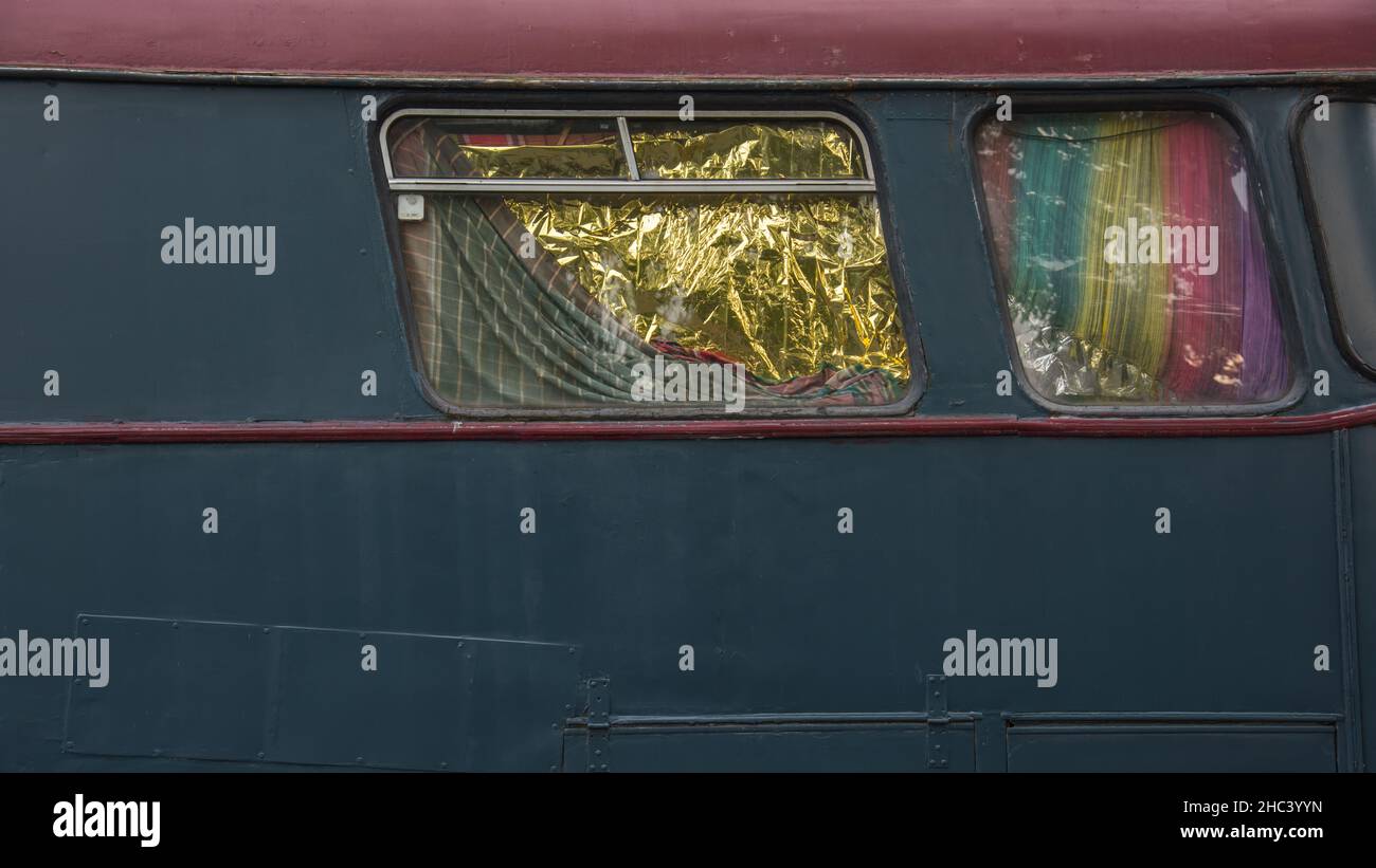 The windows of the bus with colored curtains Stock Photo - Alamy