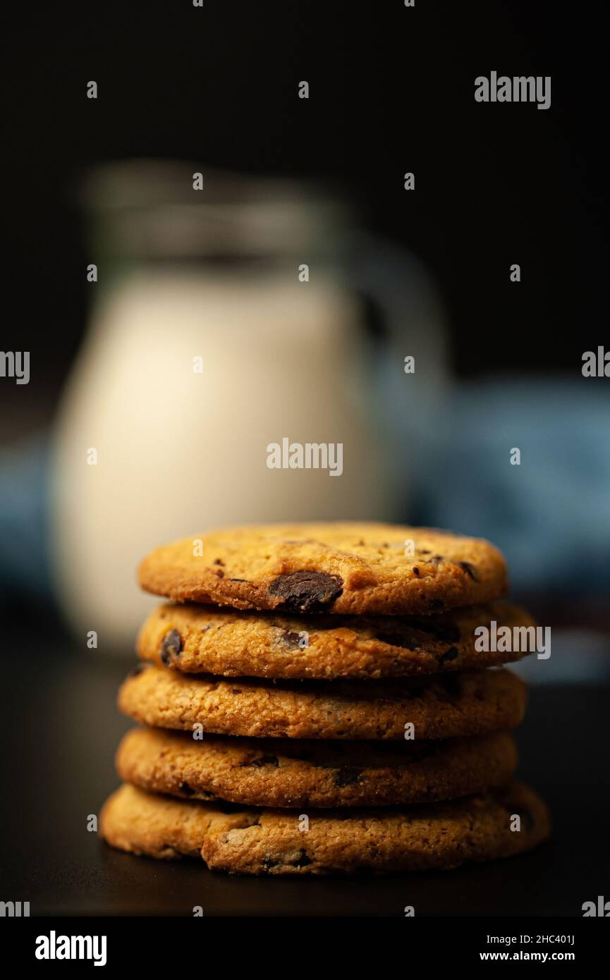 Vertical closeup of the stacked cookies on dark background. Selected ...