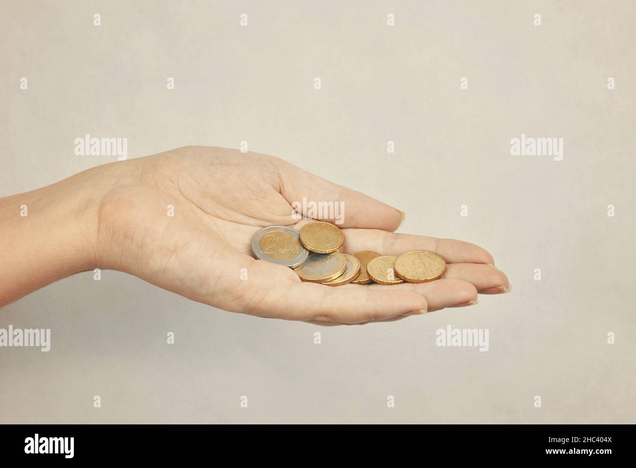 Coins in person's hands Stock Photo - Alamy