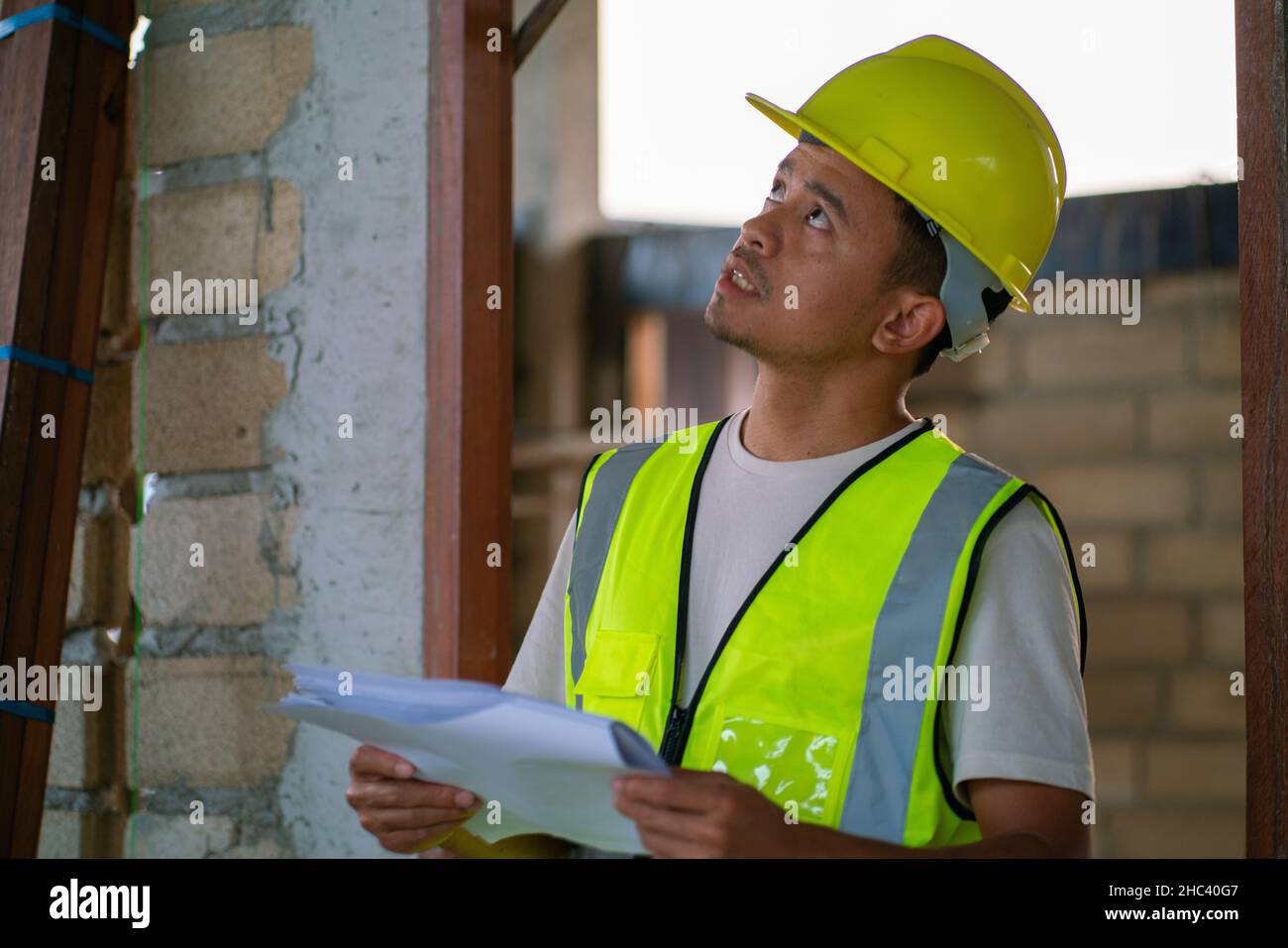 Foreman working in modern house building with notebook innspecture ...