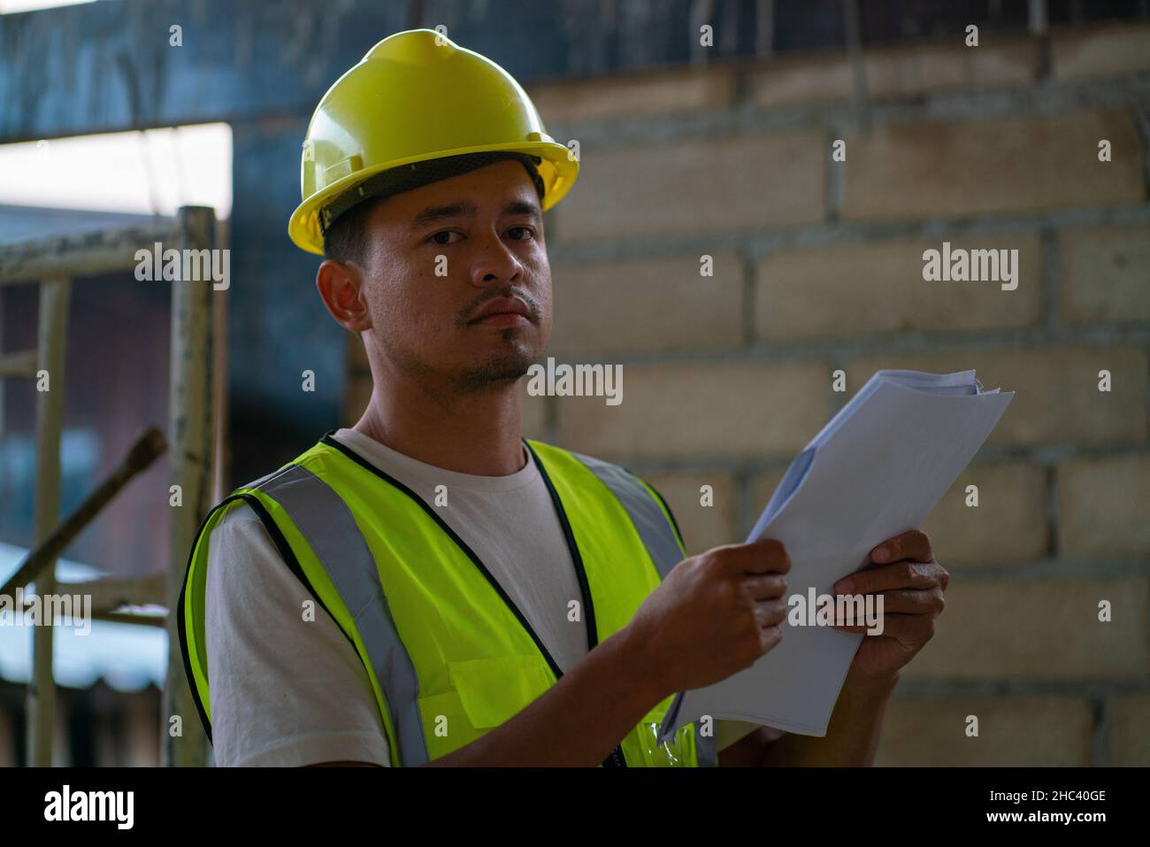 Foreman working in modern house building with notebook innspecture ...