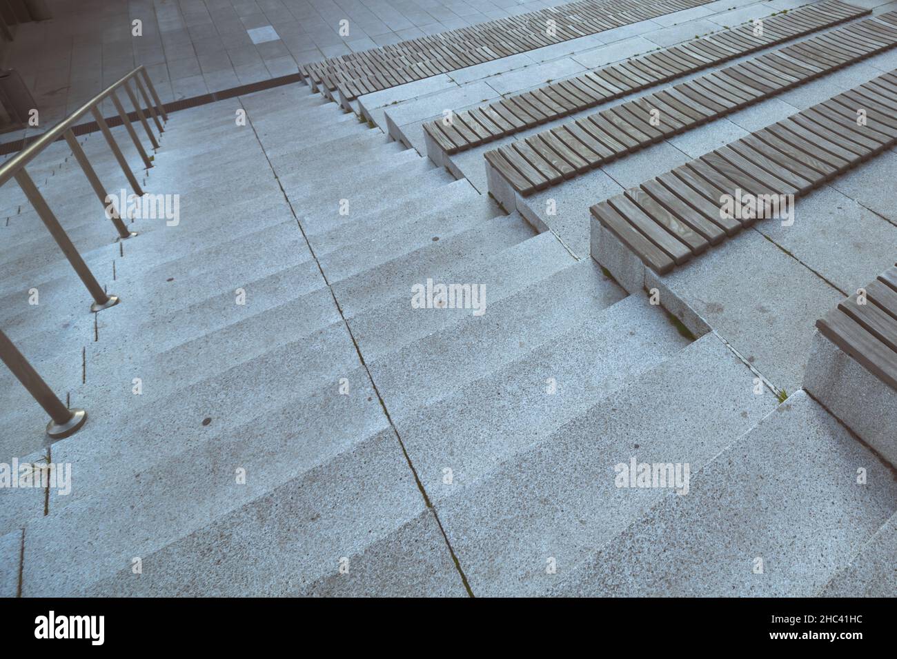 Staircase with seats. Wooden steas on the concrete stairs on outdoor of ...