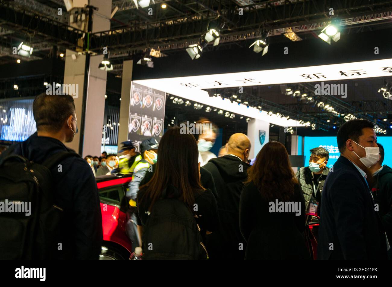 Zhang Yazhou is led away after her protest atop a Tesla at the 2021 ...