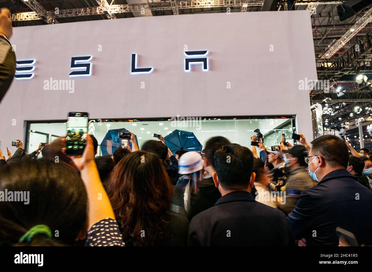 Zhang Yazhou is led away after her protest atop a Tesla at the 2021 ...