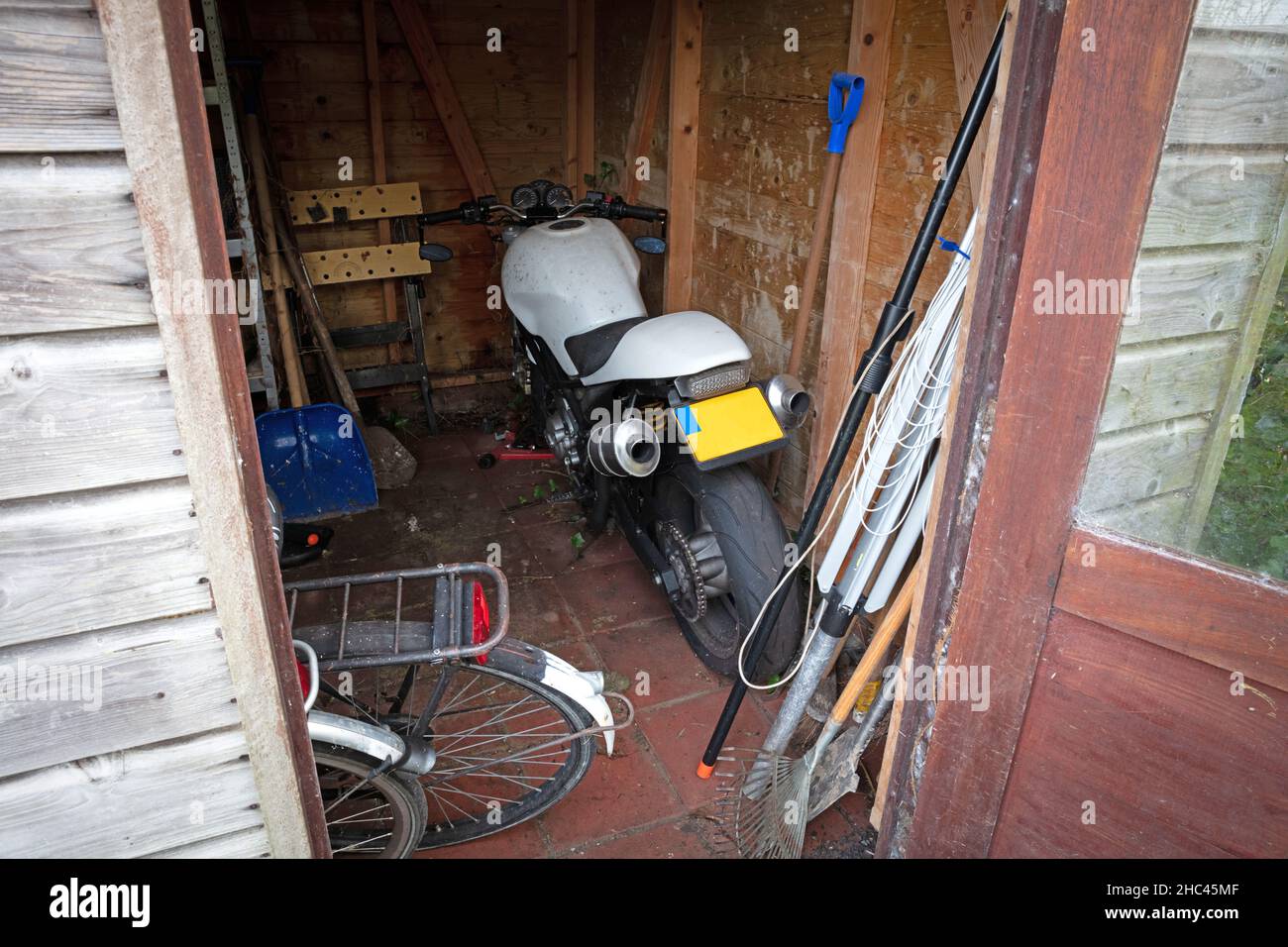 Old and dirty motorcycle in a shed, overgrown, selective focus Stock ...
