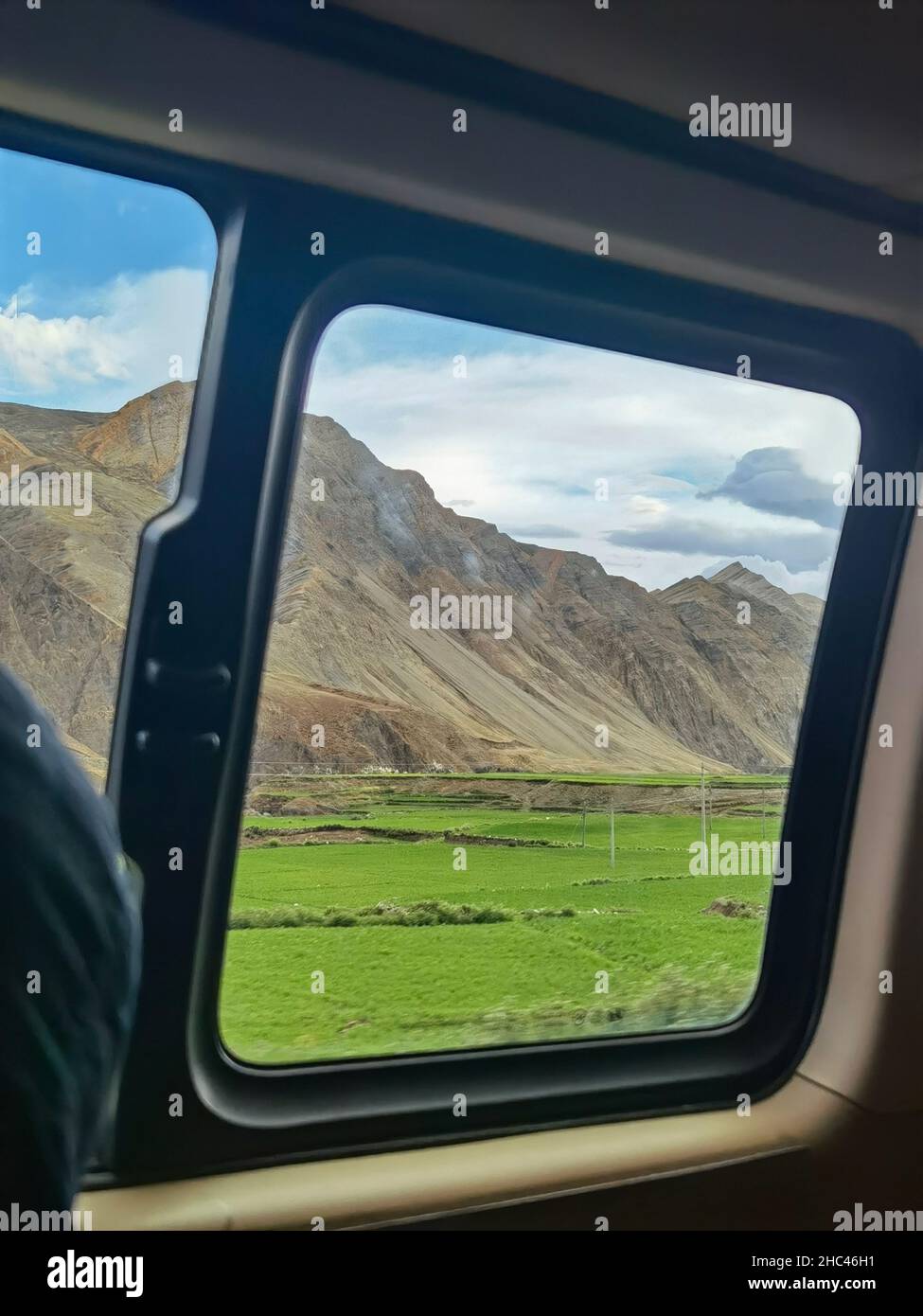 Vertical shot of a beauiful mountainous landscape captured from a car ...