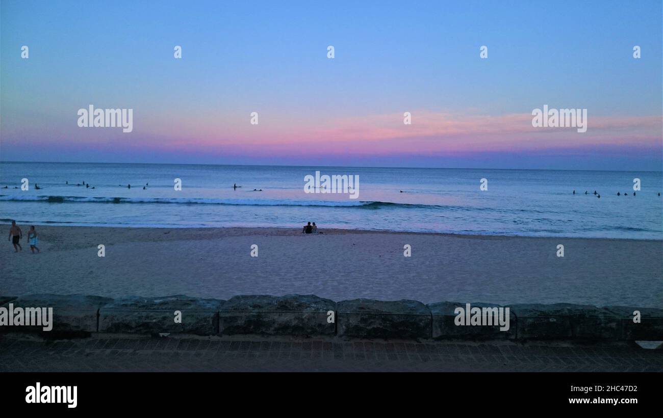 Beautiful sandy beach with people swimming and relaxing on the coast at ...