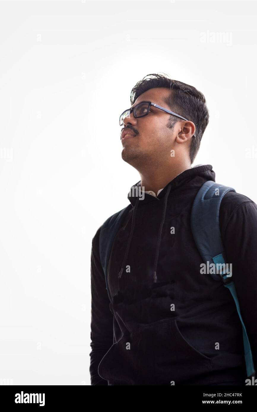isolated portrait of a young man wearing glasses looking sideways on a ...