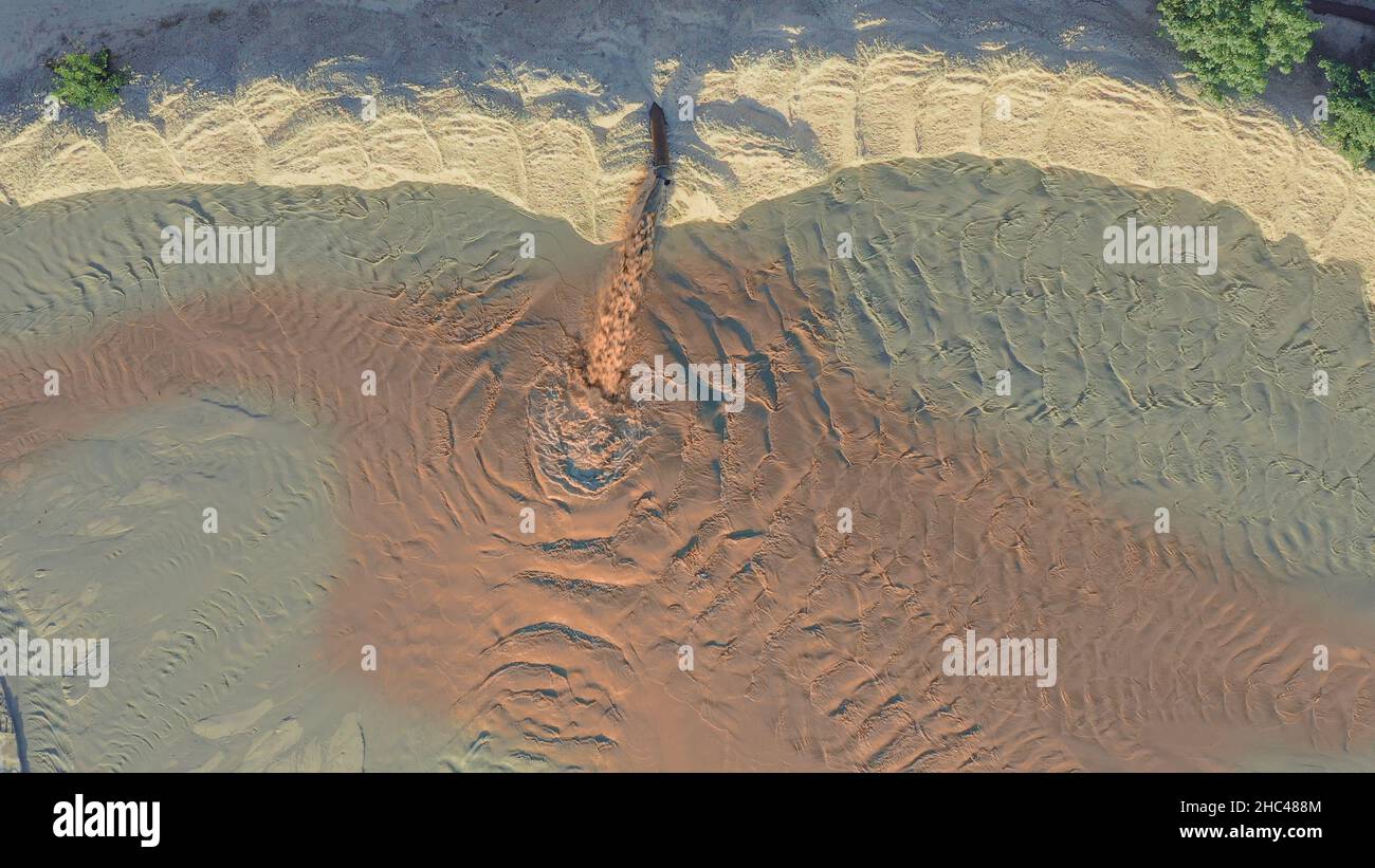 Spot rusty contamination from liquid flowing out of pipe, aerial drone ...