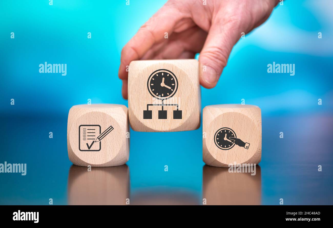 Wooden blocks with symbol of time management concept on blue background ...