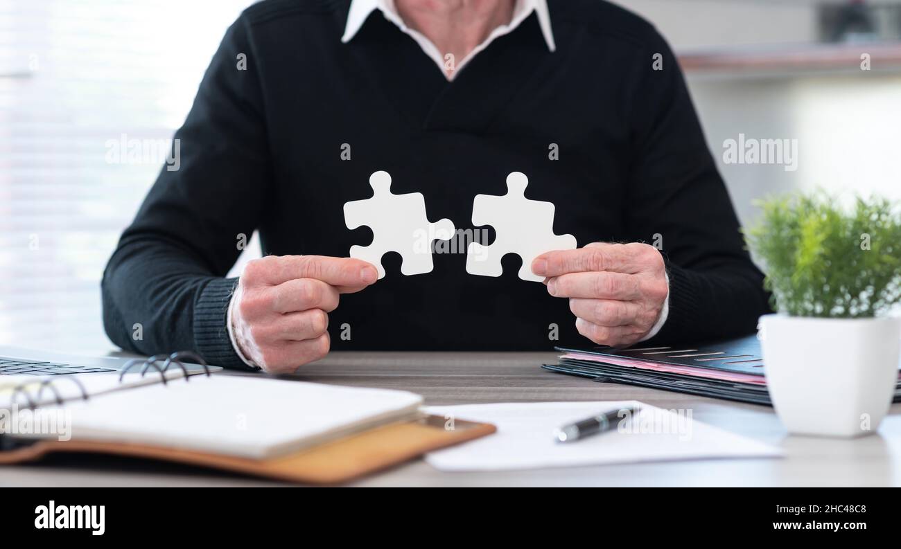 Hands of businessman joining two puzzle pieces, teamwork concept Stock ...