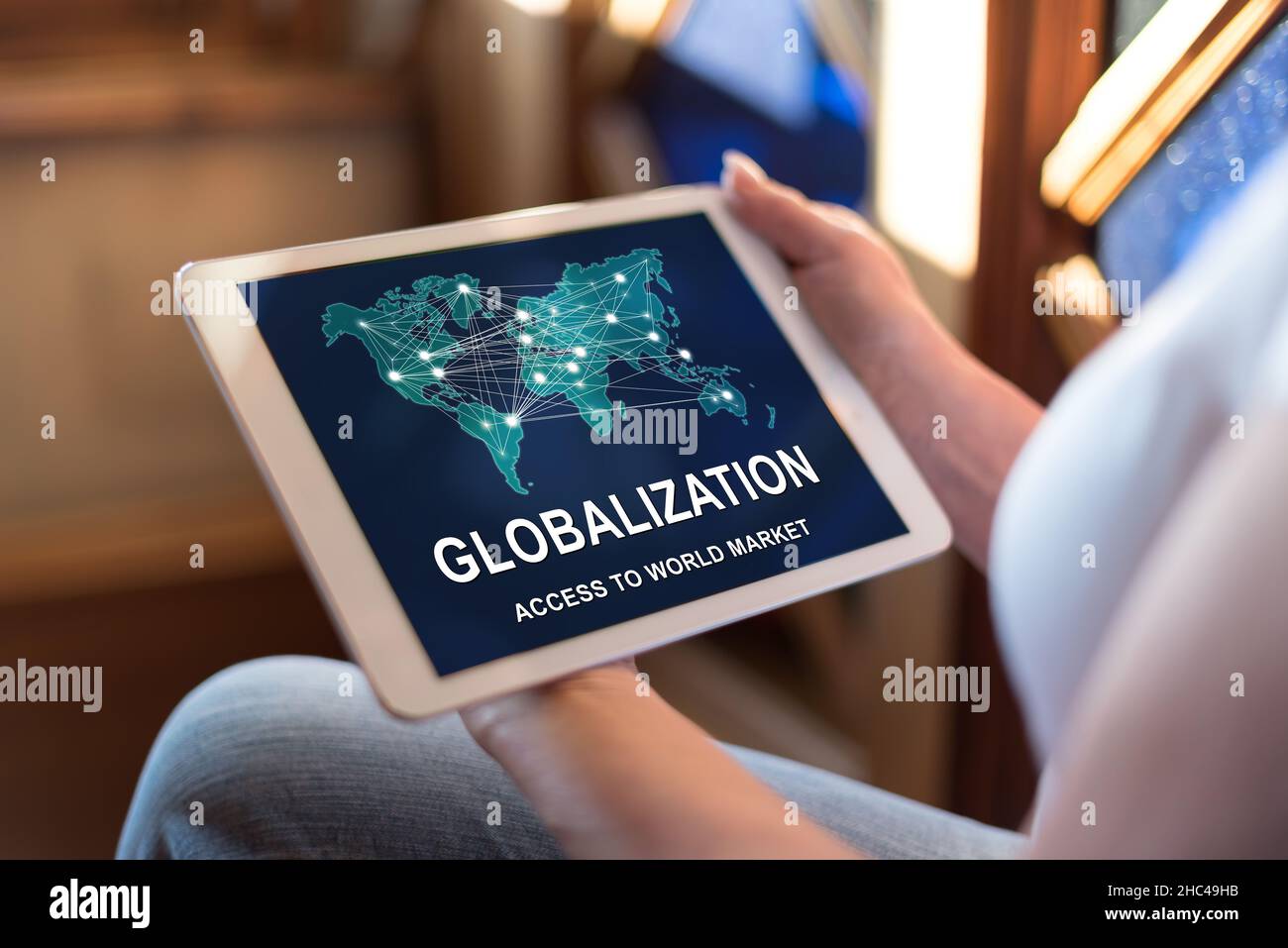 Woman holding a tablet showing globalization concept Stock Photo - Alamy