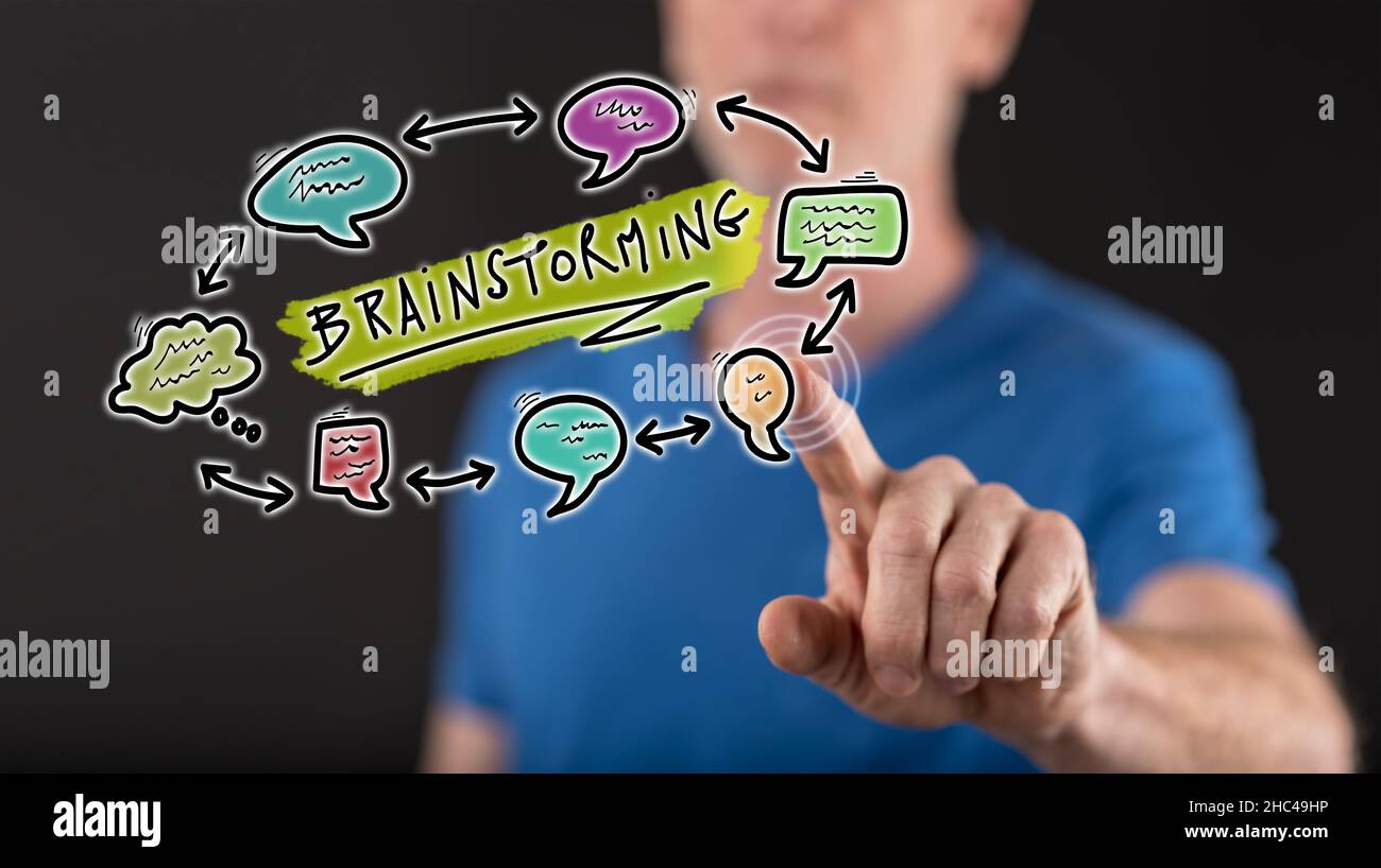 Man touching a brainstorming concept on a touch screen with his finger ...