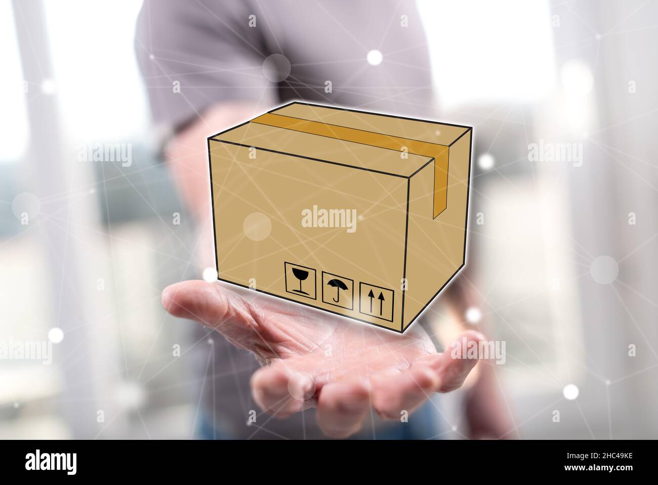 Packaging concept above the hand of a man in background Stock Photo - Alamy