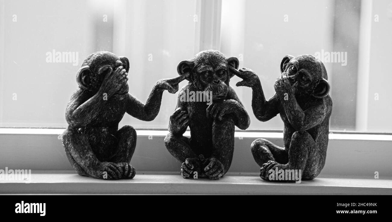 Grayscale shot of monkey figurines covering mouth, ears and eyes Stock ...