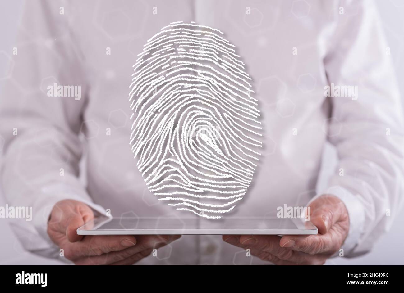 Fingerprint security system concept above a tablet held by a man in ...