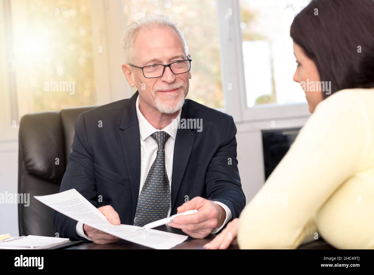 Consultant advising young woman at office, light effect Stock Photo - Alamy