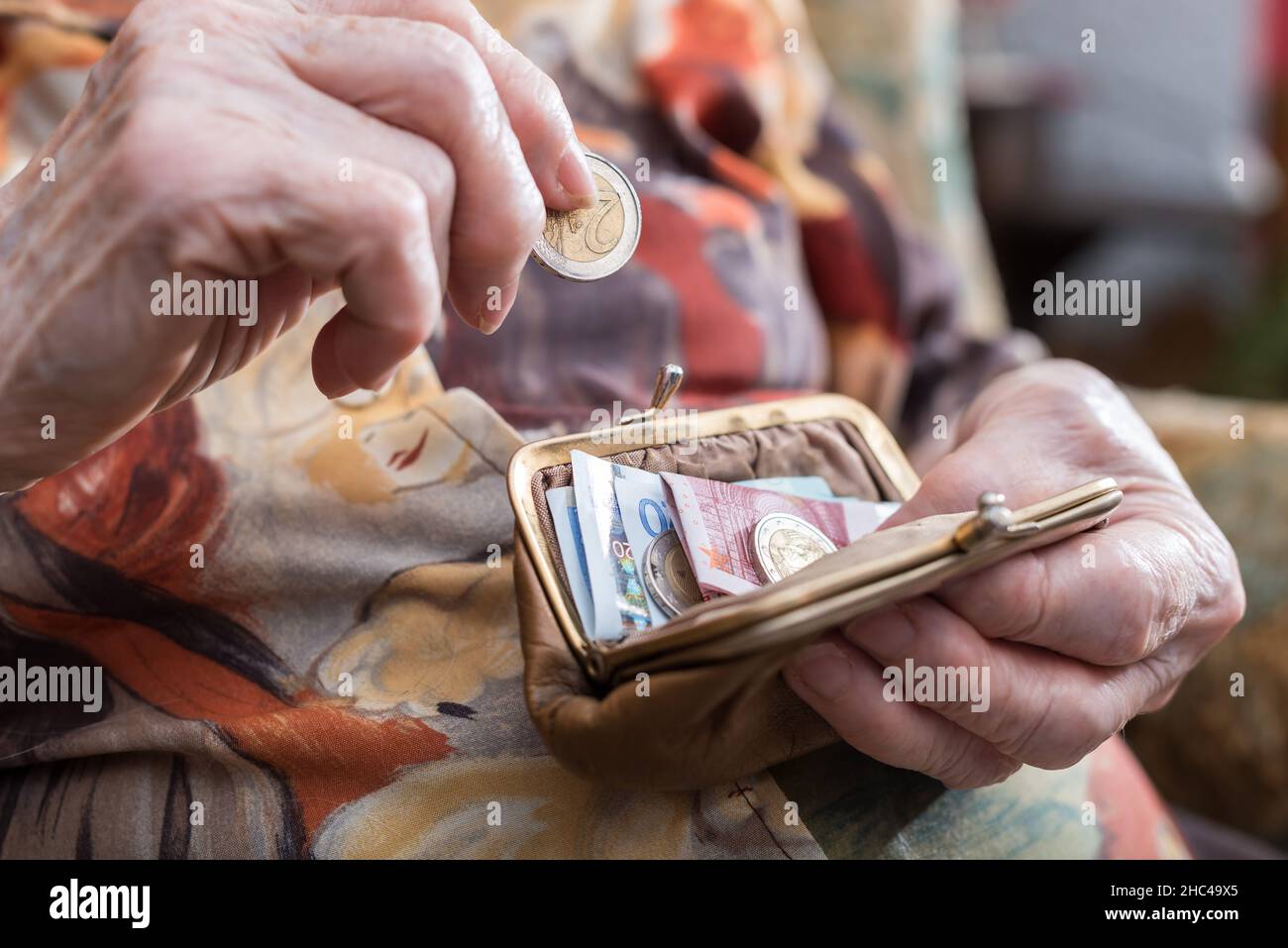 Old woman sitting at home counting her money Stock Photo - Alamy