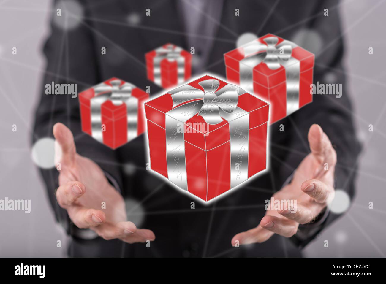 Gift concept above the hands of a man in background Stock Photo - Alamy