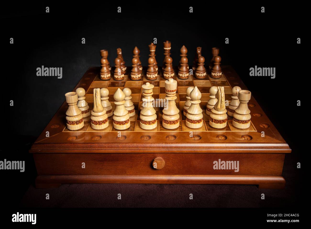 Chess pieces of wood on a beautiful chessboard. A puzzle game with ...