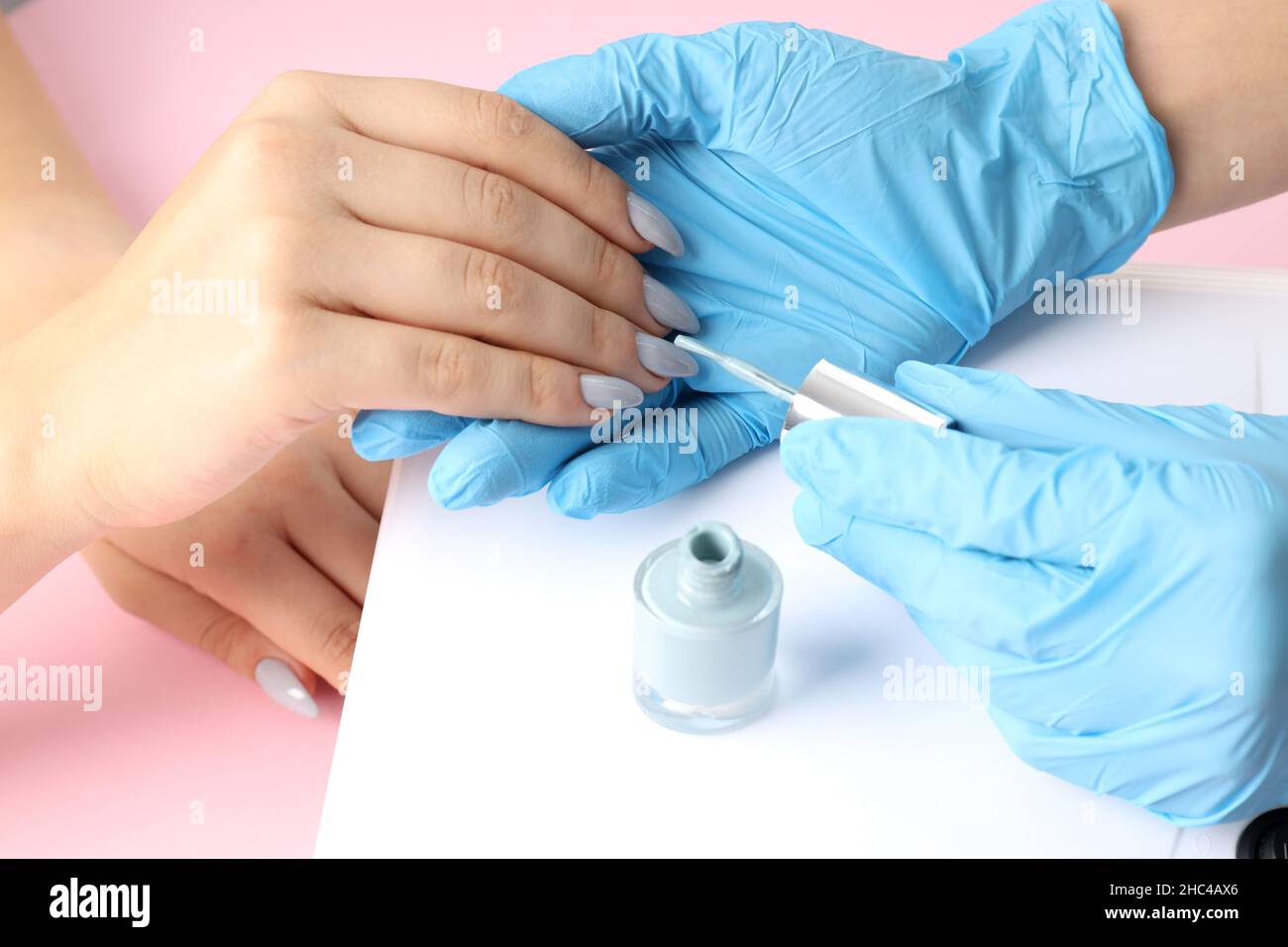 Nail care procedure on pink background, close up Stock Photo - Alamy