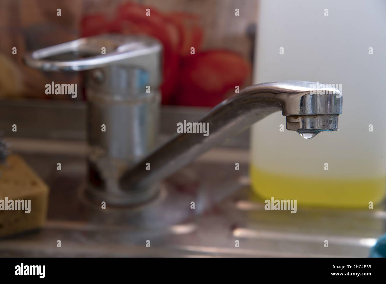 The water tap over the sink .Dishwashing detergent and sponge Stock ...