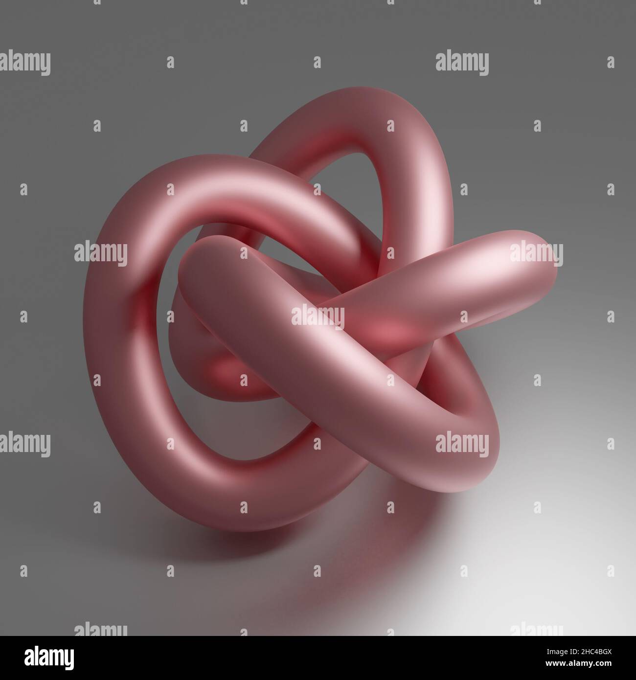 Copper wire tied in a knot, on a gray background Stock Photo - Alamy