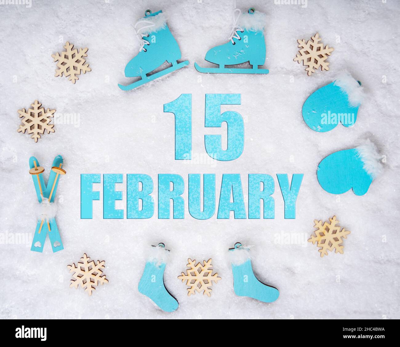 February 15th. Sports set with blue wooden skates, skis, sledges and ...