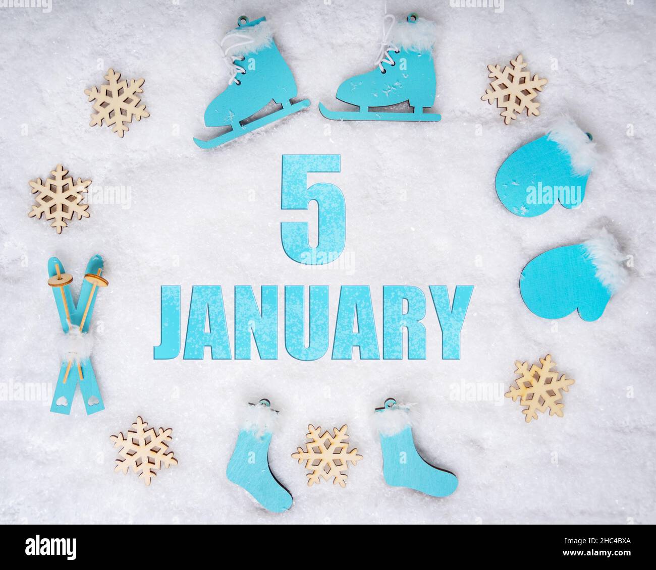 January 5th. Sports set with blue wooden skates, skis, sledges and ...