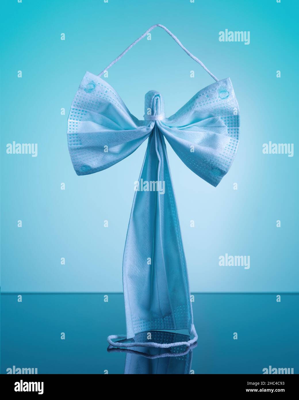 Protection face mask in the form of an angel on a blue background Stock ...