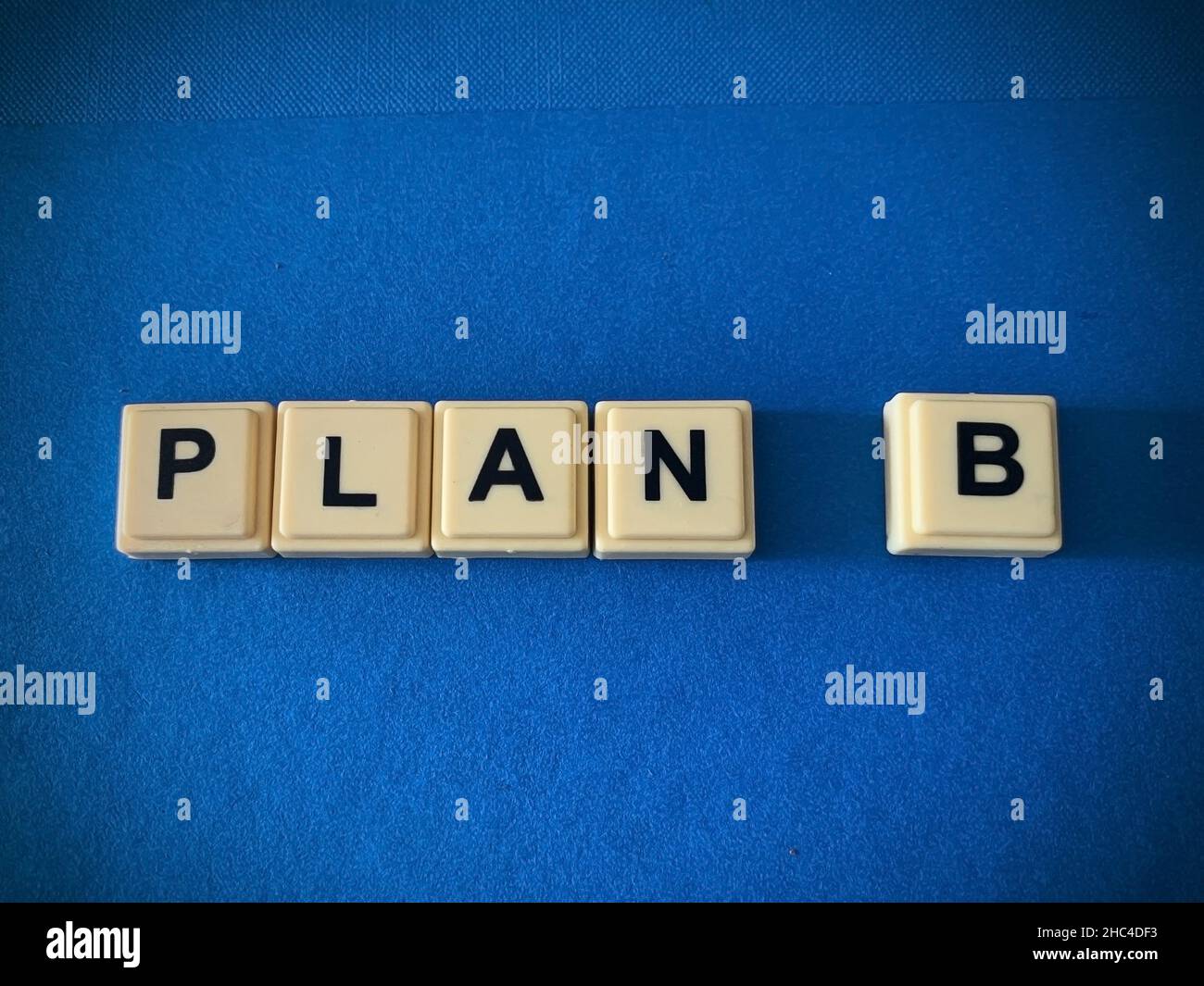 Words PLAN B on cube blocks with dark blue background Stock Photo - Alamy