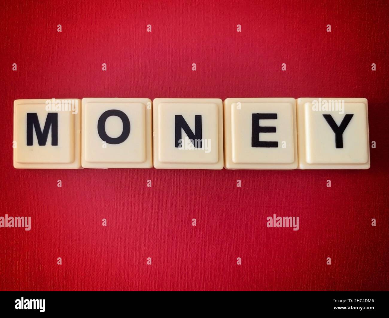 Word MONEY on cube blocks with dark red background. Business concept ...