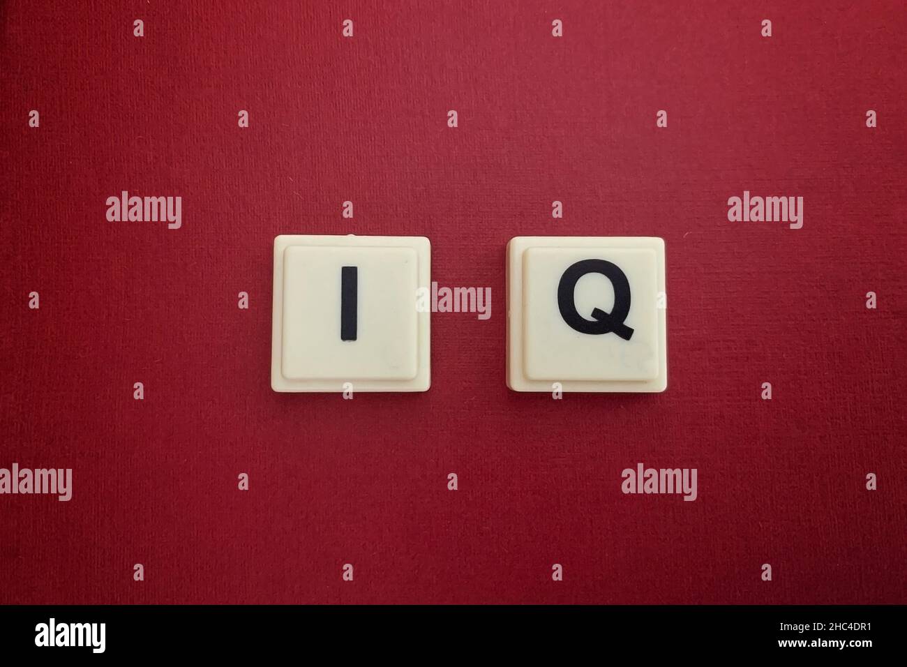 I and Q letter on cube blocks with dark red background Stock Photo - Alamy