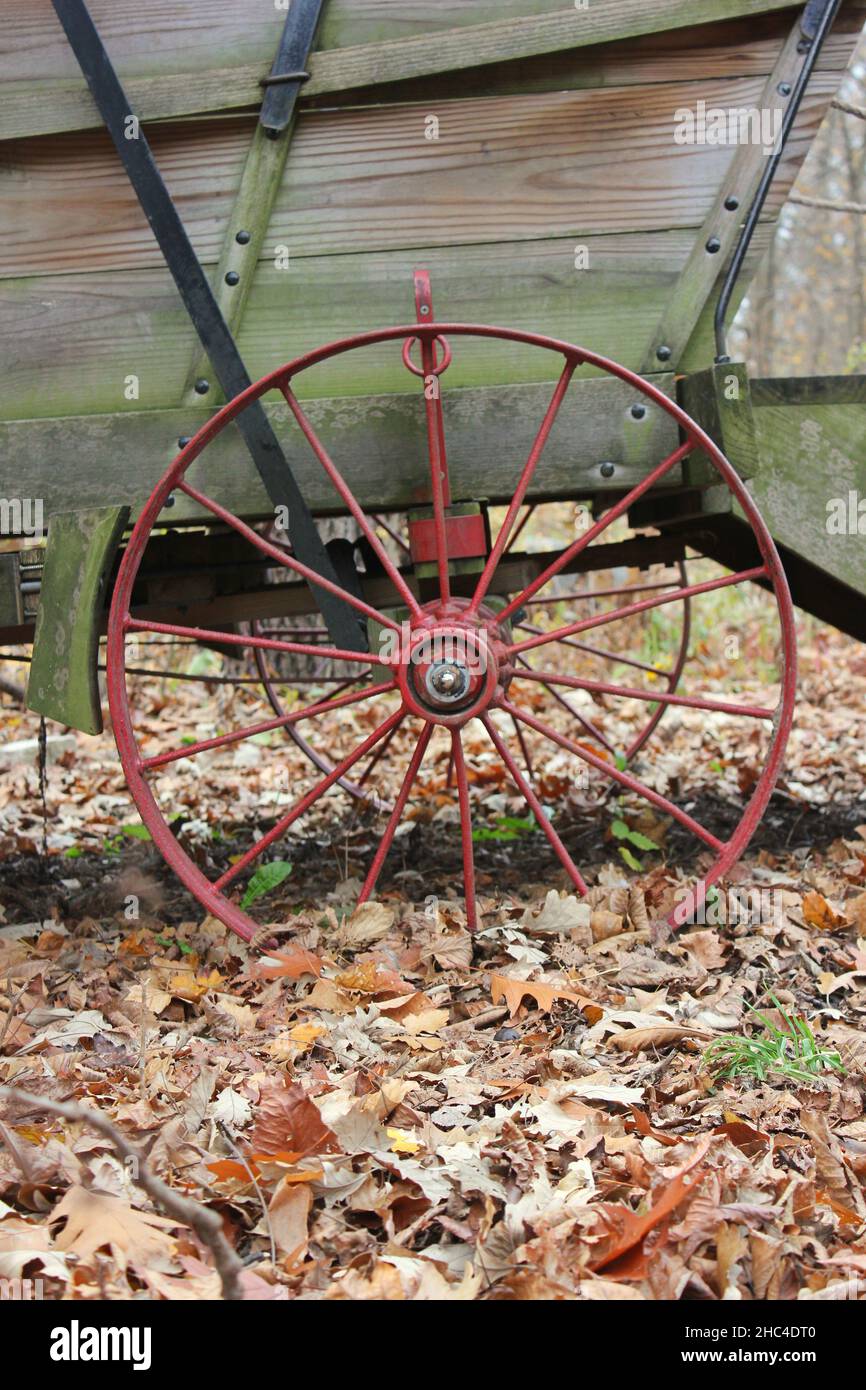 Bright red painted covered wagon wheel Stock Photo - Alamy
