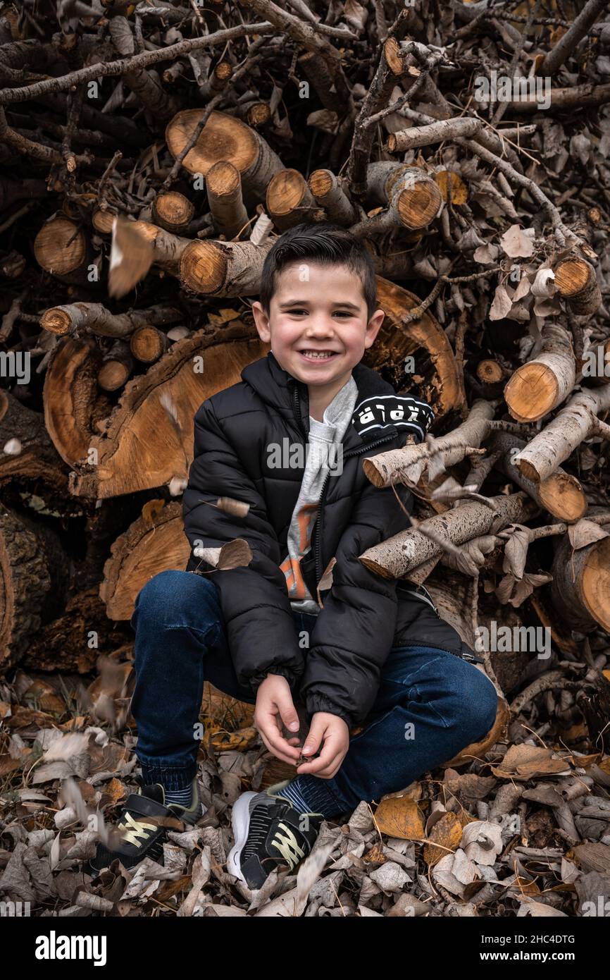 A young kid posing his best and smiling and trying to be a model for ...