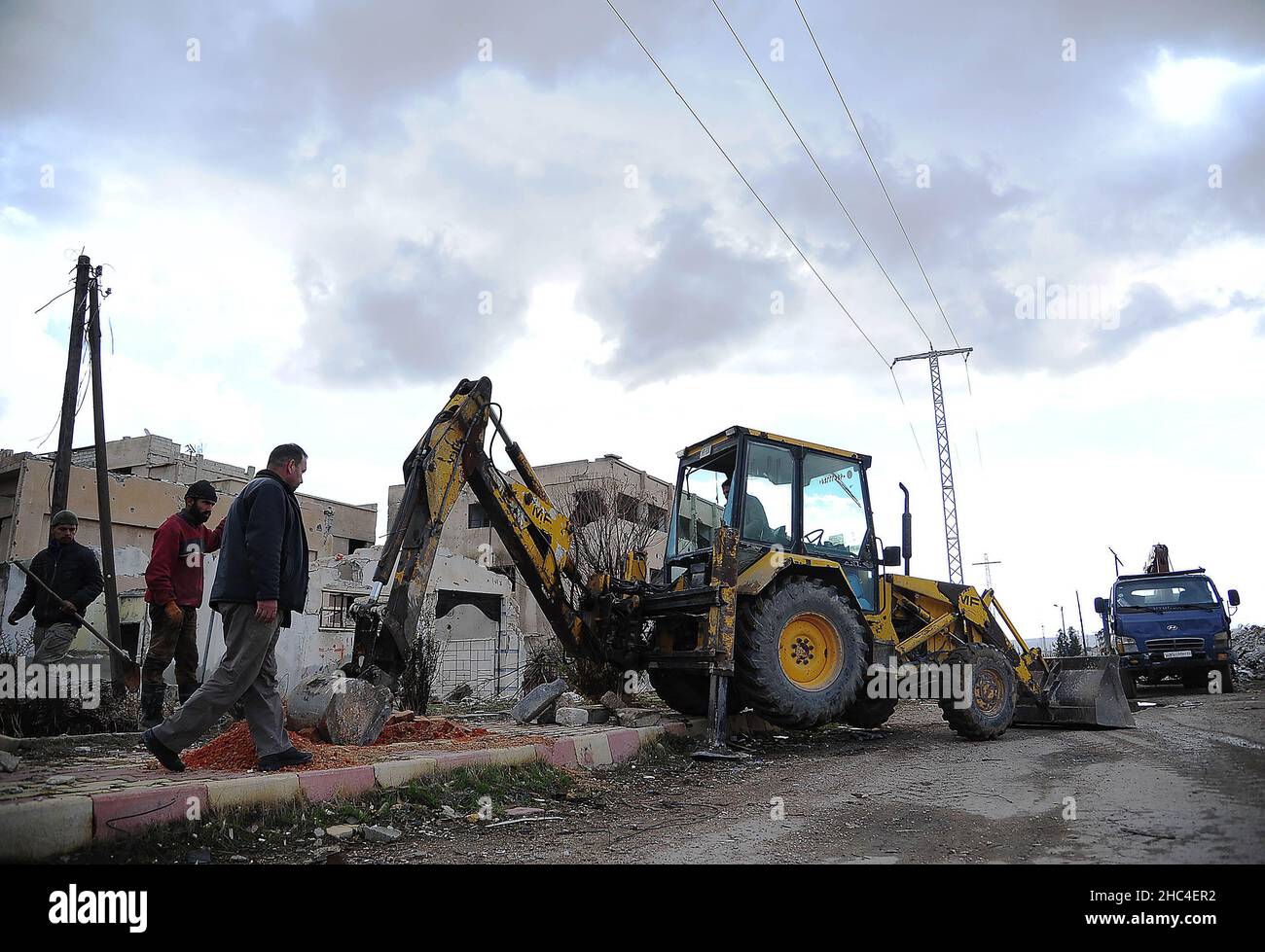 Damascus, Syria. 23rd Dec, 2021. Workers rehabilitate damaged ...