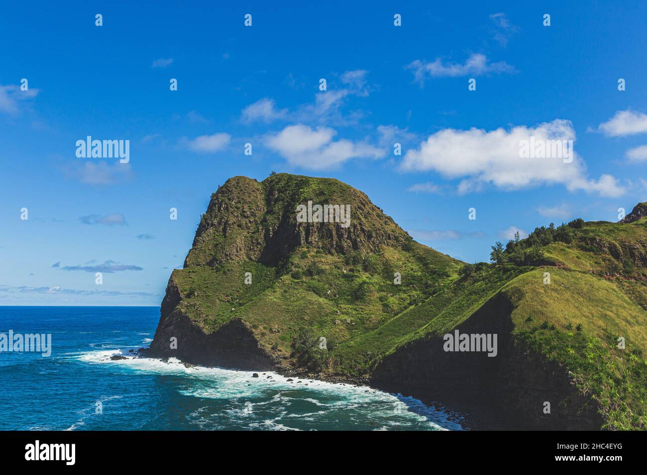 Kahakuloa Head juts out into the ocean. Green volcanic island peak ...