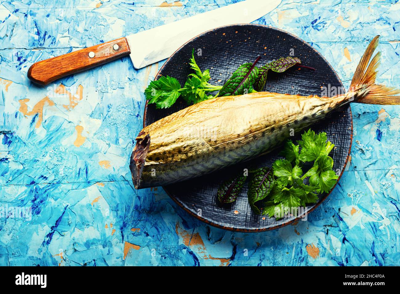 Whole tuna mackerel smoke-dried in spices. Salted scomber on the plate ...