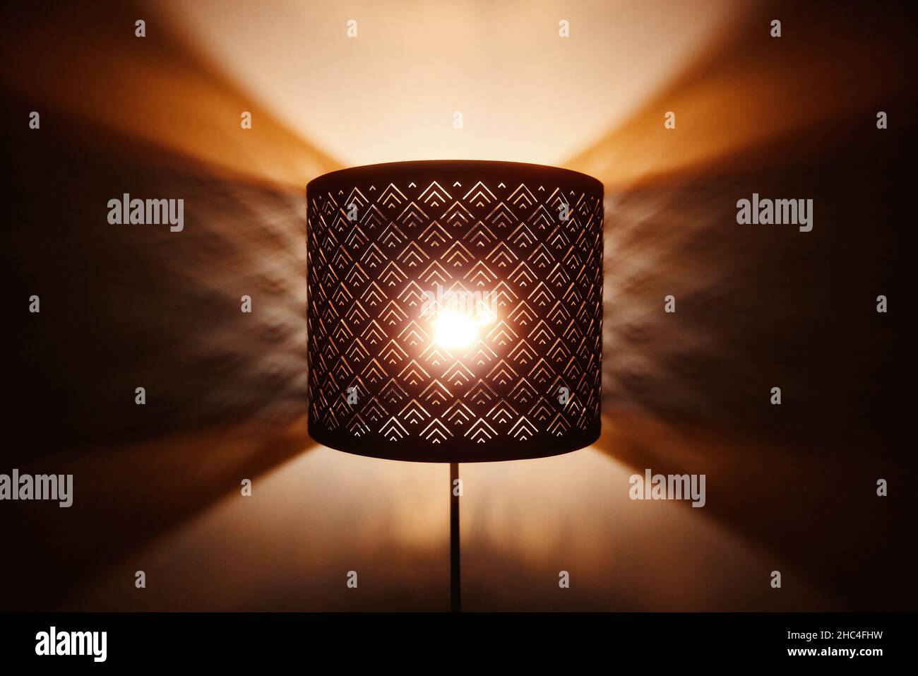 Floor lamp light. Rays of light through the holes in the lamp floor ...