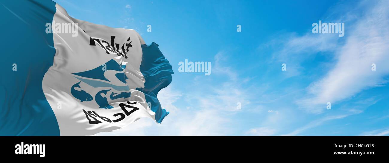 flag of Iqaluit, Nunavut , Canada at cloudy sky background on sunset ...