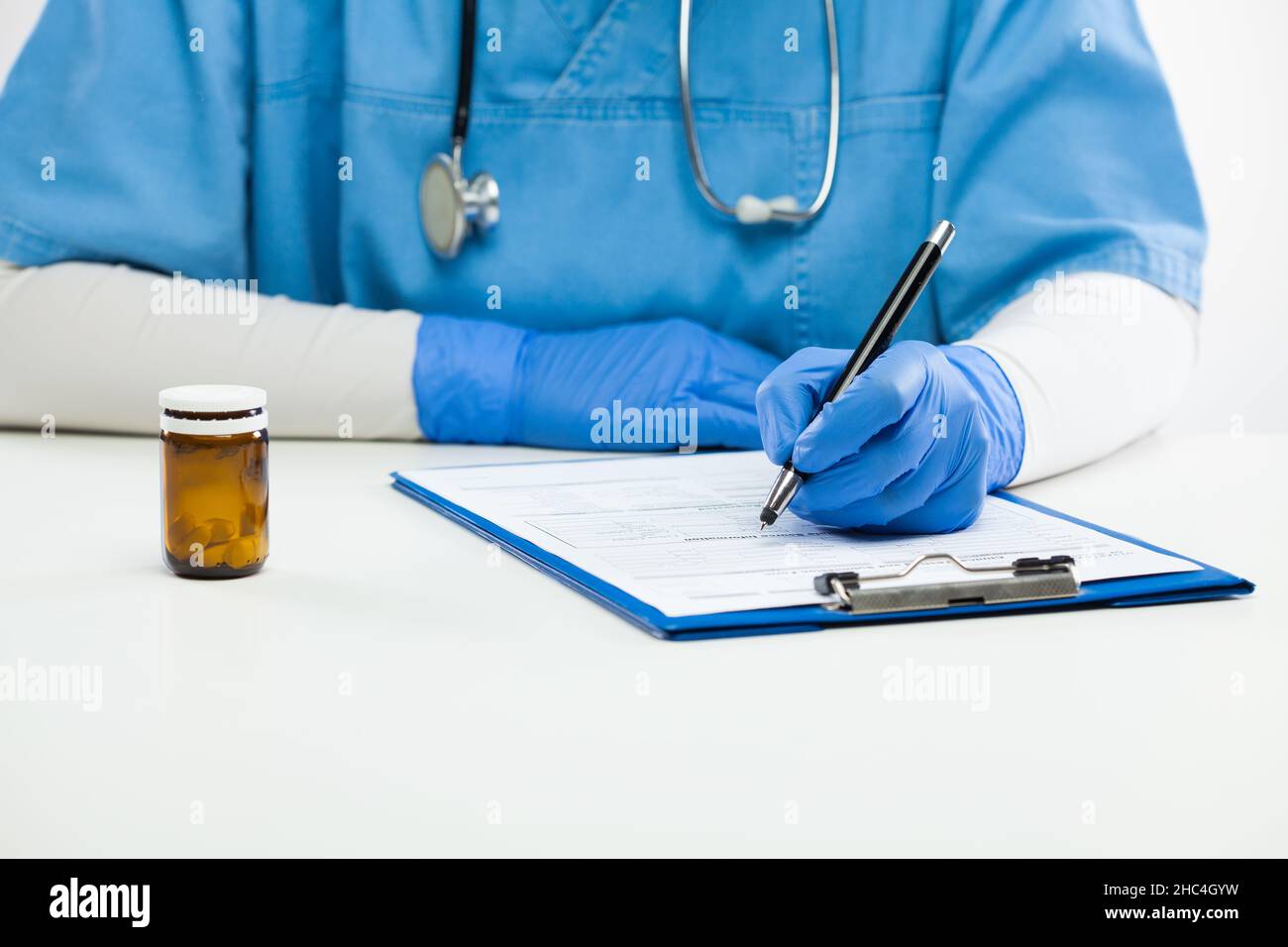 Close up of young woman doctor working at her desk in hospital,General ...
