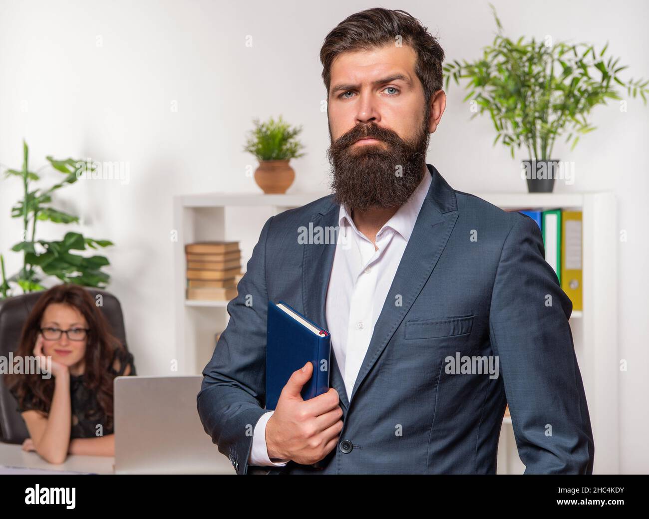 Serious man professional employer in suit stand in front woman employee ...