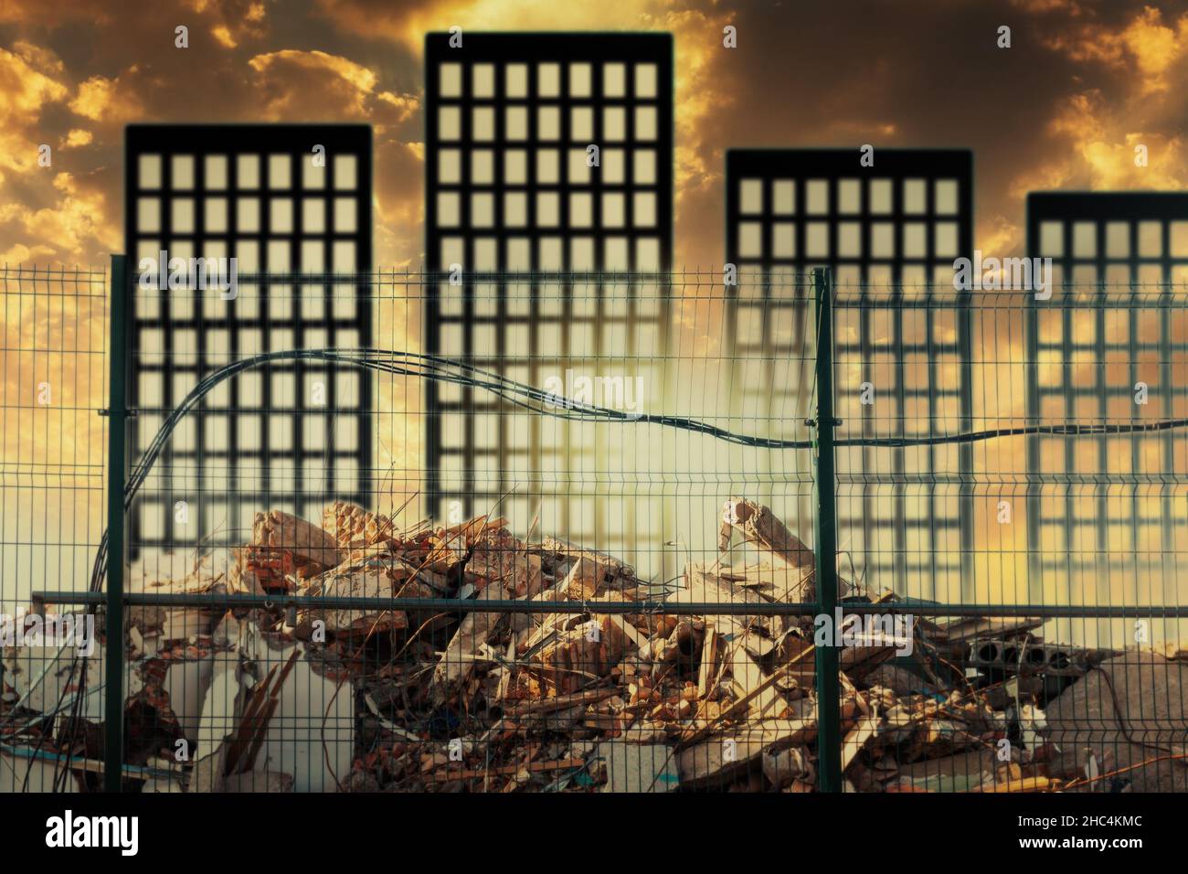 The ruins of a destroyed buildings behind the fence. Against the ...