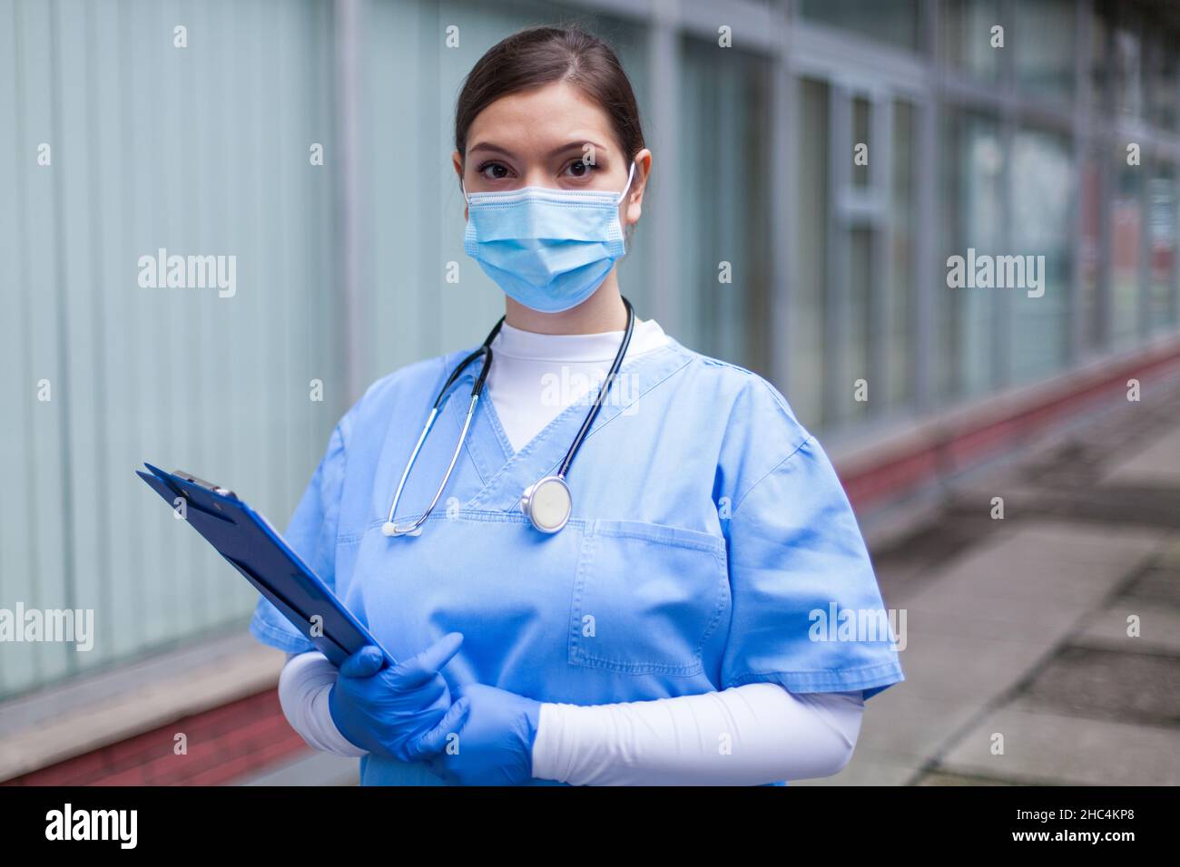 Portrait of worried stressed female medical doctor,standing outside the ...