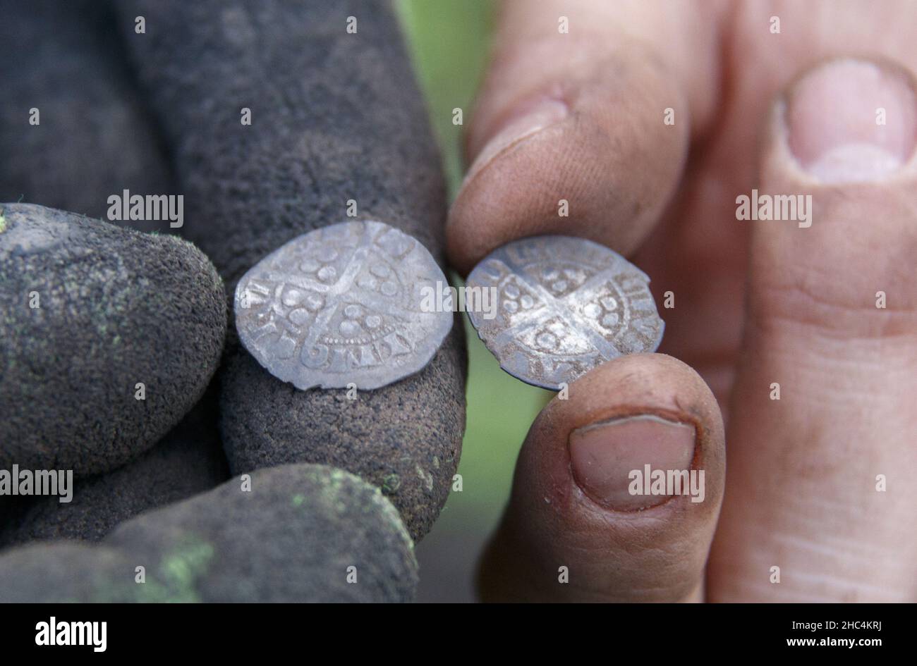 English middle age coins in finders hands Stock Photo - Alamy